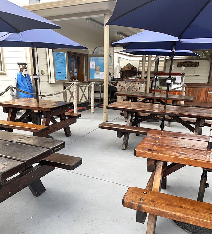 Picnic tables awaiting their next round of seafood enthusiasts. Each weathered plank could tell stories of countless "Oh my God" first bites.