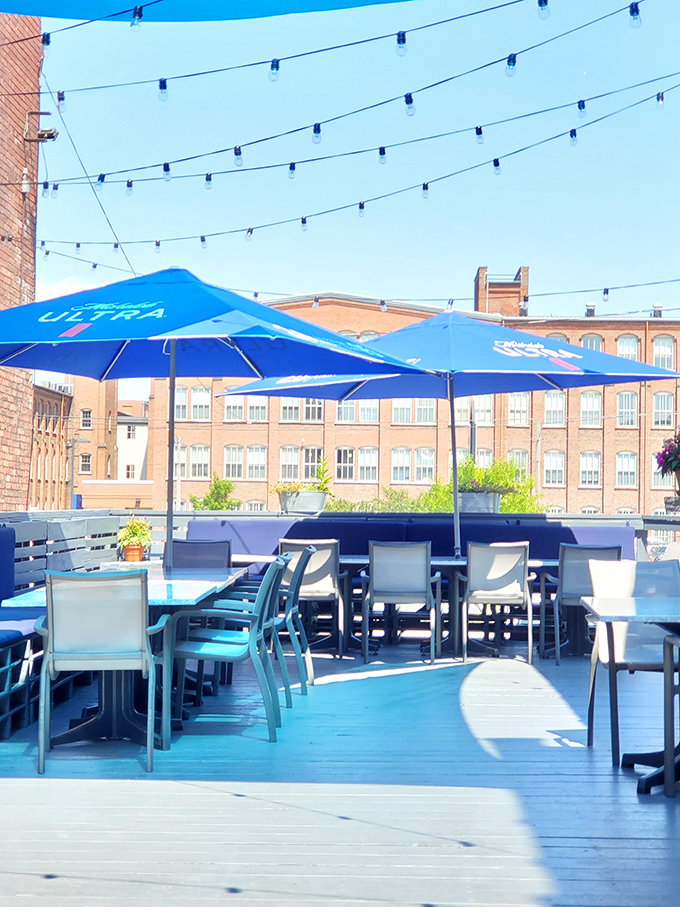 A rooftop patio where blue umbrellas mirror the sky. The kind of place where "just one drink" turns into "let's order appetizers" and then dinner.