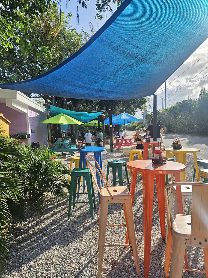 Al fresco paradise! Multicolored tables under blue shade sails create the perfect outdoor dining spot for soaking up that Keys atmosphere.