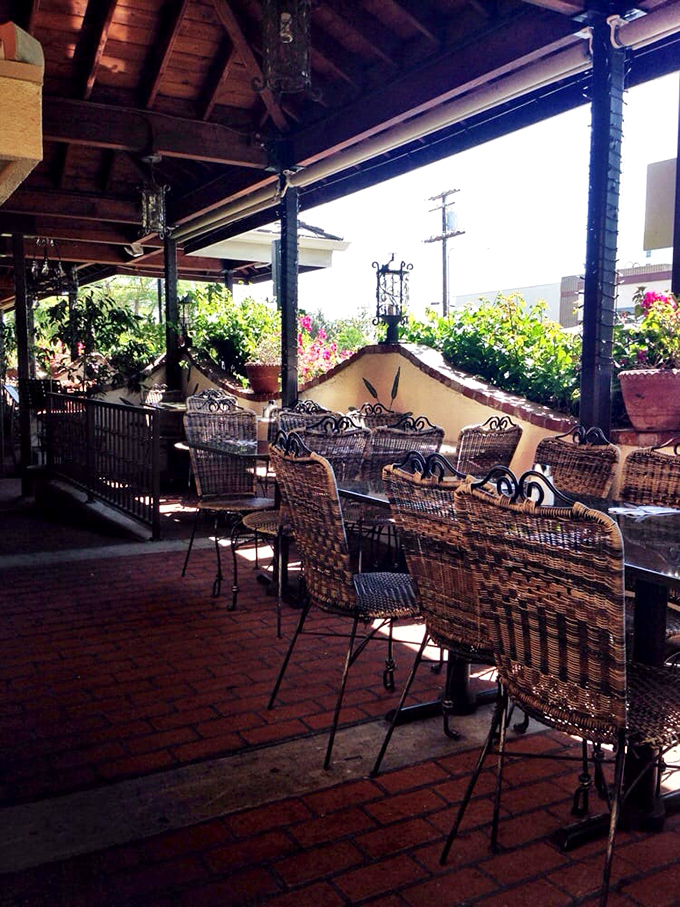 The outdoor seating area whispers promises of leisurely brunches and people-watching beneath the California sun. Wicker chairs have never looked so inviting.
