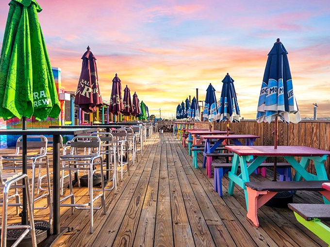 Sunset transforms the outdoor seating into a postcard-worthy scene. Those colorful picnic tables have witnessed countless "best meal ever" declarations.