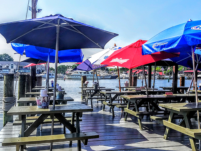Colorful umbrellas shade wooden picnic tables, creating the perfect setting for memory-making meals where napkins are necessary and formality is forbidden.