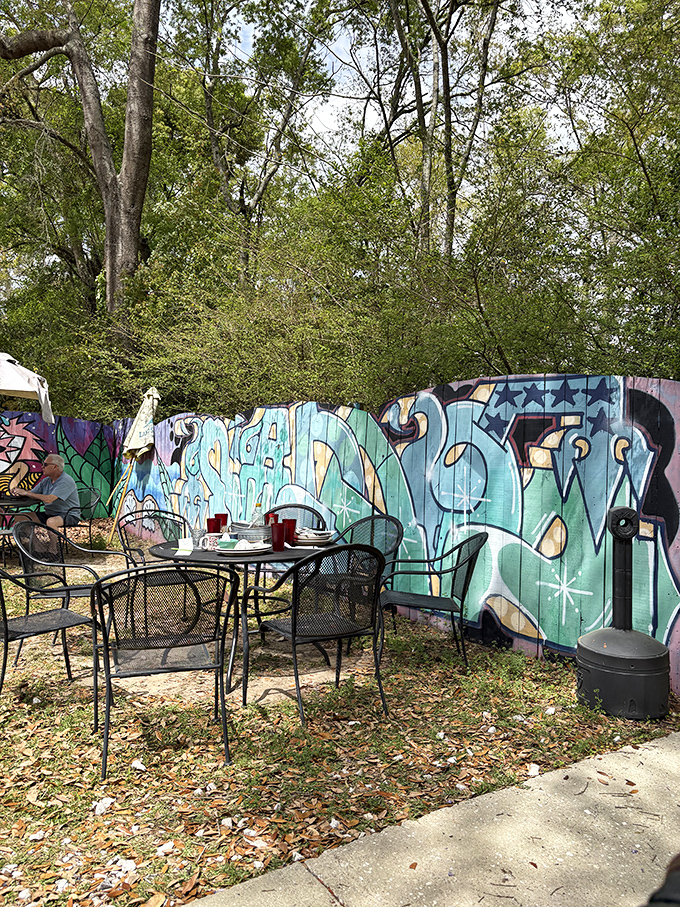 Outdoor seating with graffiti art that says "we're casual" louder than any mission statement ever could.