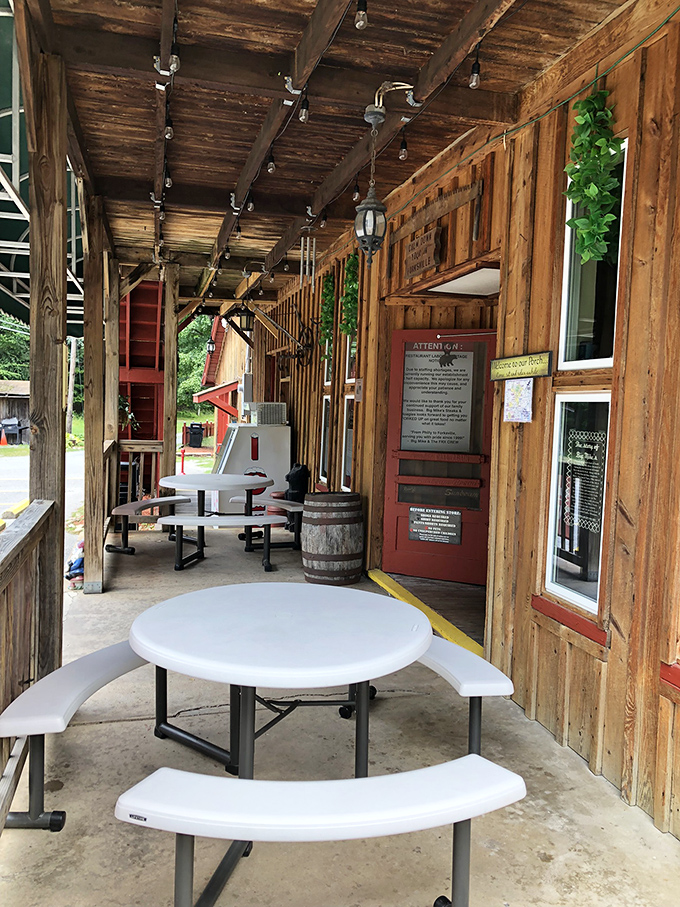 Rustic outdoor seating where fresh air enhances every bite. These picnic tables have witnessed more food joy than a cooking show audience.