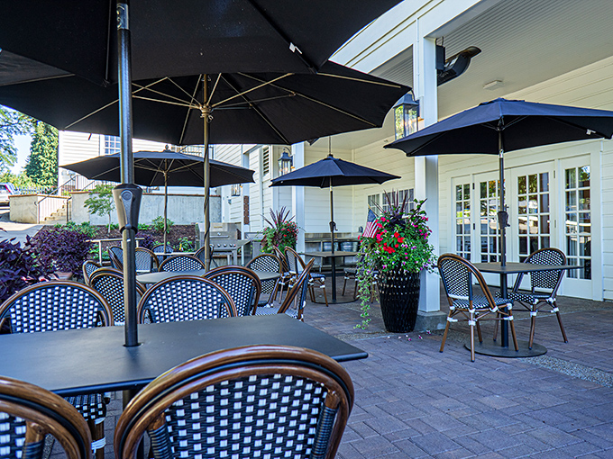 The outdoor patio beckons with navy umbrellas and bistro chairs—perfect for those Oregon summer evenings when the air feels like silk.