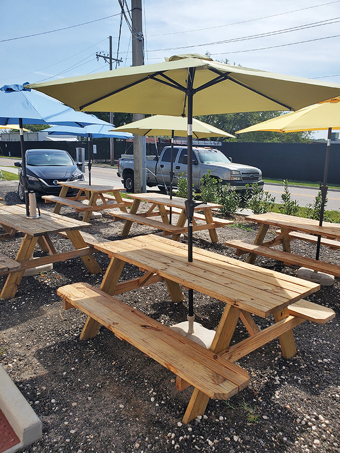 Outdoor picnic tables under cheerful yellow umbrellas&mdash;because sometimes barbecue just tastes better with a side of sunshine and fresh air.