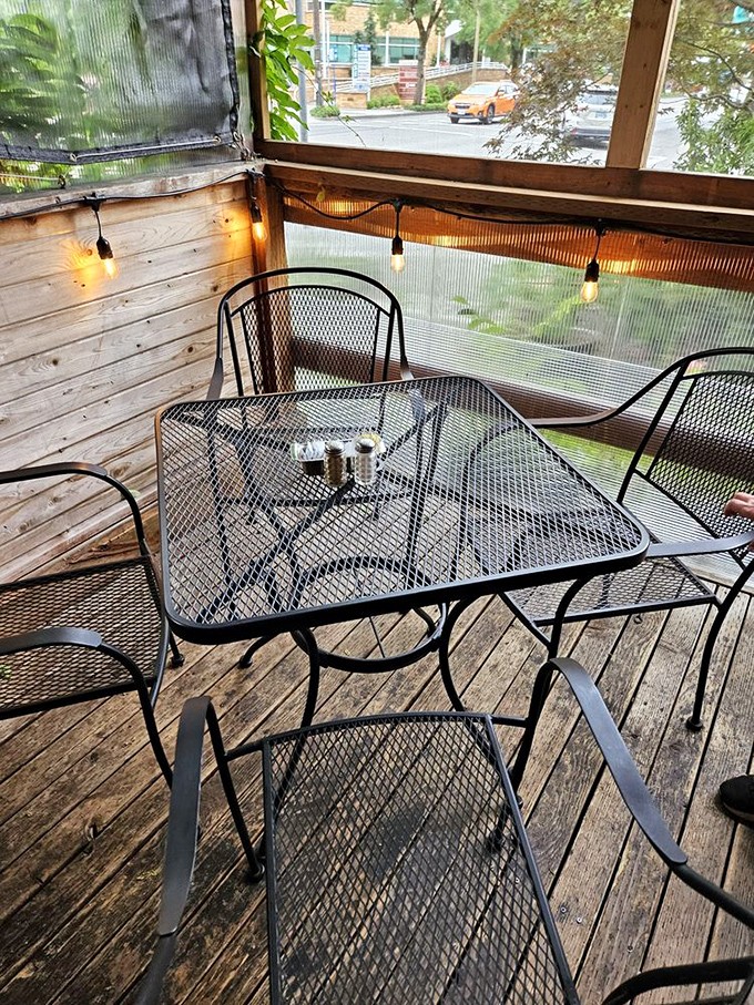 String lights and mesh tables create an outdoor dining space that feels both rustic and refined&mdash;perfect for savoring that last bite of French toast.