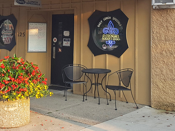 A simple outdoor table where summer conversations bloom as colorfully as those flowers. The perfect spot to digest both food and gossip.