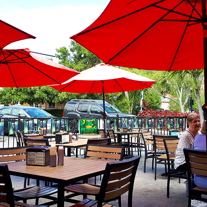 Red umbrellas provide shade while you contemplate whether you have room for another helping of brisket. Spoiler alert: you always do.