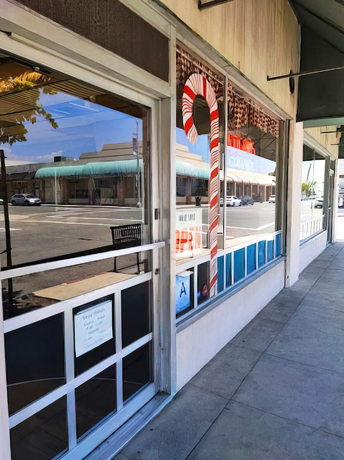 A candy cane sentinel guards the entrance to this temple of treats.