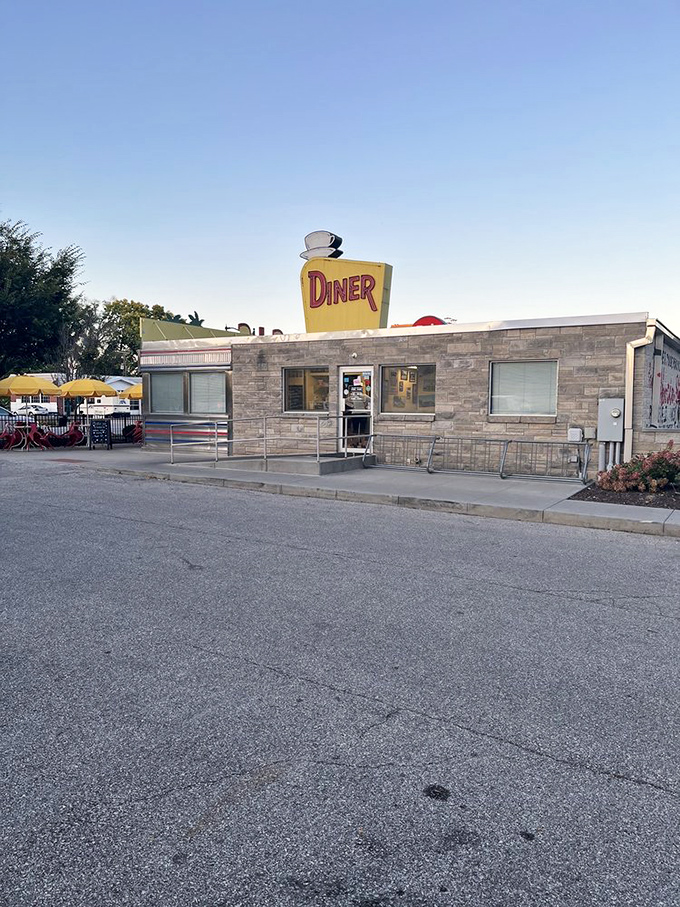 The classic diner silhouette against a clear Indiana sky proves that sometimes the best things come in stainless steel packages with a coffee cup on top.