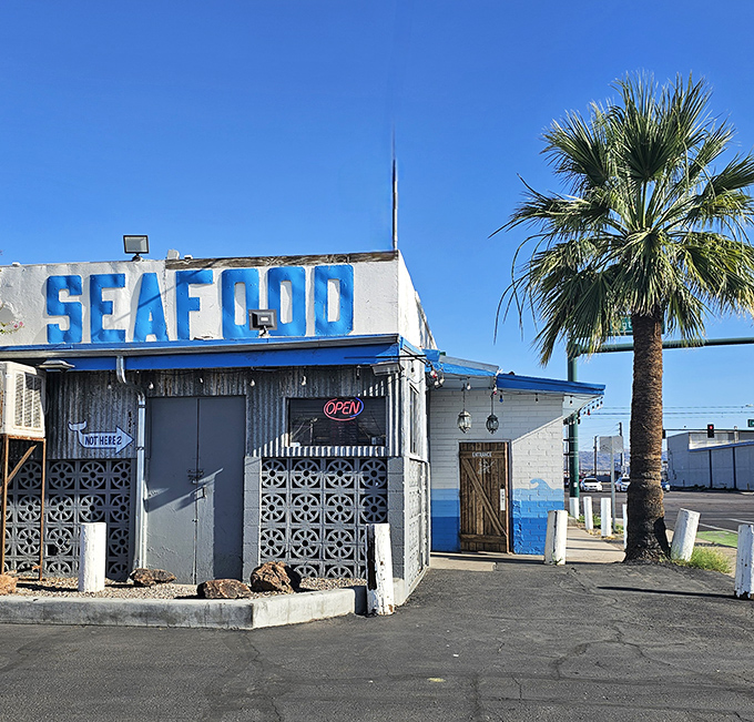 The "SEAFOOD" sign stands tall against the Arizona blue sky, a beacon for hungry travelers seeking maritime flavors in cactus country.
