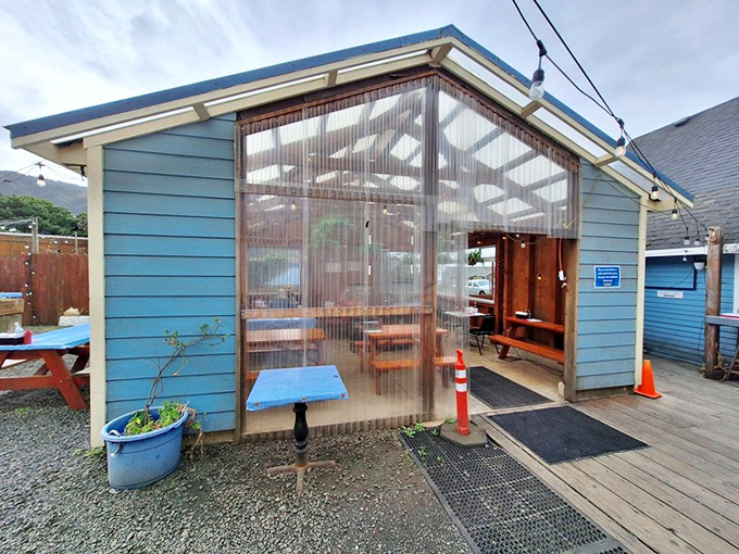 The covered outdoor seating area offers protection from coastal weather while keeping you connected to the seaside atmosphere.