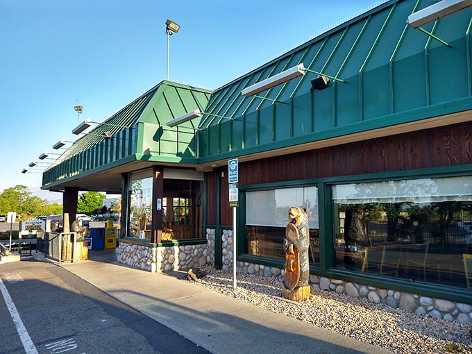 Morning light bathes the green-roofed diner, where wooden bear sculptures patiently wait to welcome the day's first wave of hungry patrons.