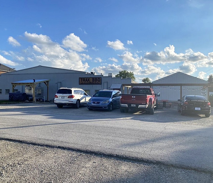 The parking lot at Trax BBQ&mdash;where vehicles gather like pilgrims at a smoky shrine, their owners inside experiencing meat-induced euphoria.