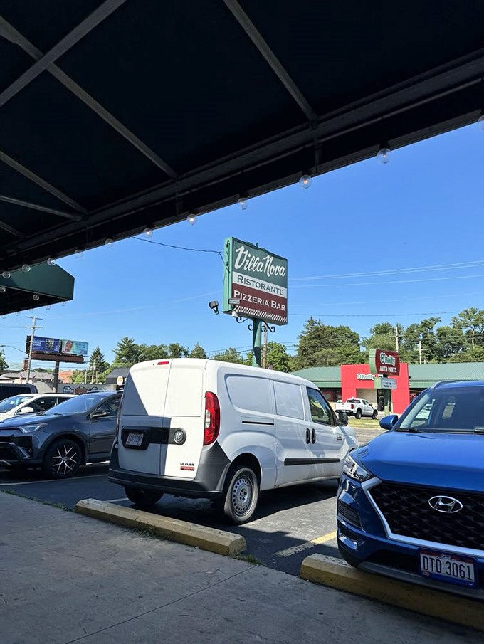The parking lot view reveals why finding a spot can be challenging at peak hours. That sign has guided hungry Columbus residents home for generations.