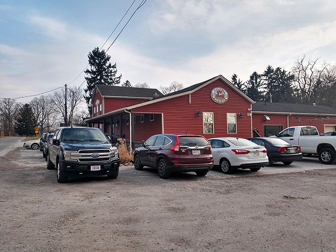 A full parking lot is the universal sign language for "the food here is worth the wait." Cars gather like hungry pilgrims at this red BBQ shrine.