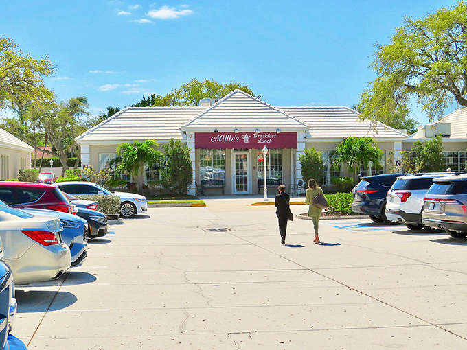 The exterior view reveals Millie's true form: a breakfast oasis in a sea of asphalt, with palm trees standing guard over precious pancakes within.