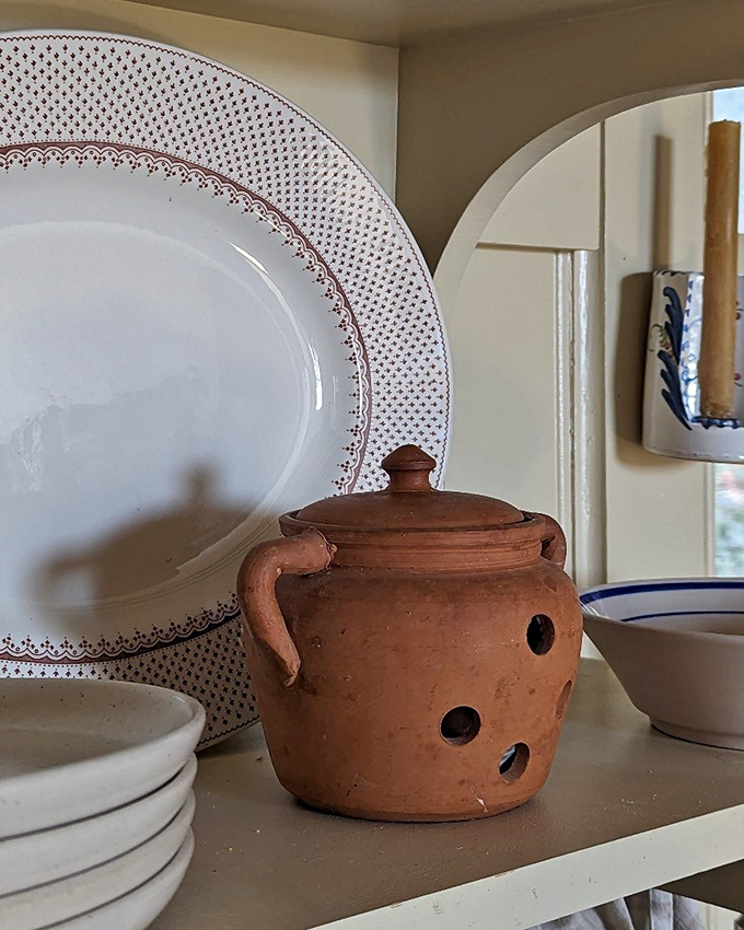 Terracotta charm meets practical pottery. This little pot could become home to your herbs or simply a rustic accent in your kitchen display.