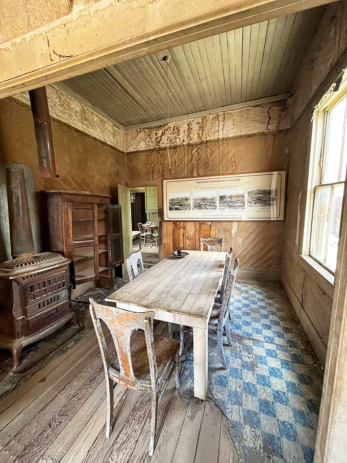 The dining room table waits for guests who'll never return, its blue linoleum a cheerful anachronism.