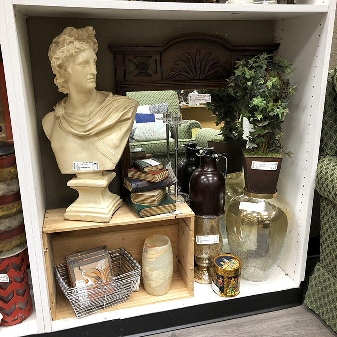 Classical meets eclectic in this curated shelf display. The bust of Apollo shares space with vintage books and glassware, creating a miniature museum of curiosities that would make Wes Anderson proud.