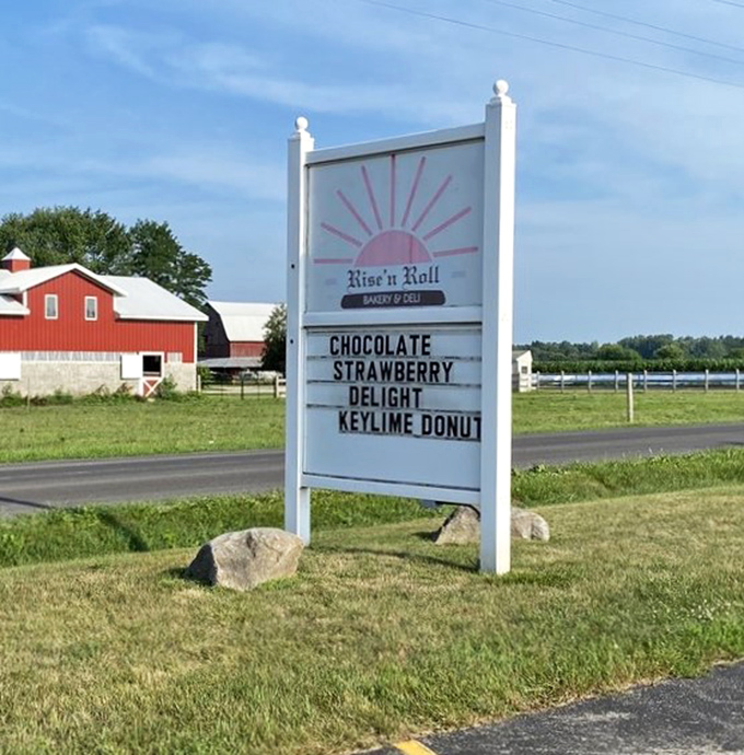 The roadside sign announces daily specials like a town crier, luring travelers with promises of "Chocolate Strawberry Delight" against Indiana's pastoral backdrop.