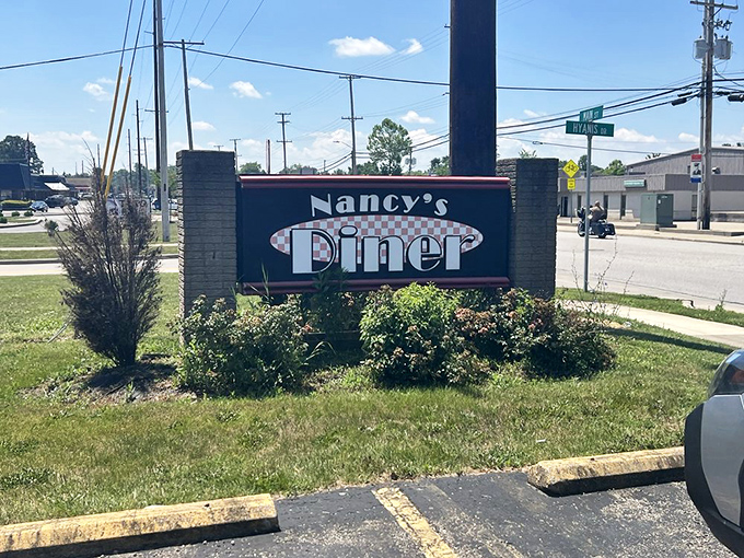 The roadside beacon that signals salvation to hungry travelers &ndash; Nancy's sign promises no gimmicks, just honest food worth pulling over for.