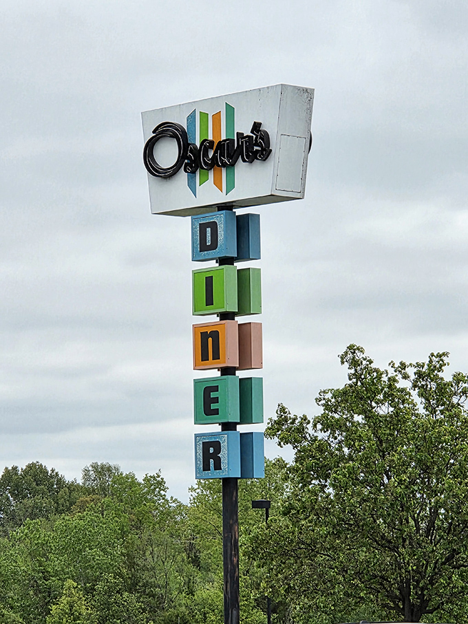 The retro vertical signage stands tall against the Missouri sky, a beacon of breakfast hope. Those colorful blocks spell "DINER" but really mean "salvation for the hungry."