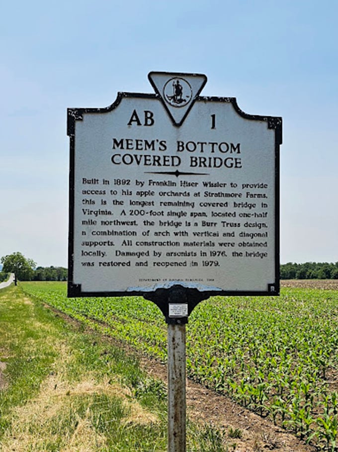 History stands still on this roadside marker, telling the tale of a bridge that refused to be forgotten, even after fire tried to claim it.