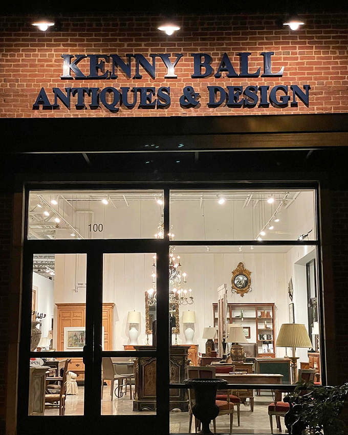 As night falls, the illuminated storefront glows like a jewelry box, promising vintage treasures for those who appreciate the past.