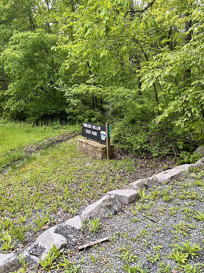 The unassuming entrance sign that marks the boundary between ordinary life and woodland escape. Like finding the door to Narnia, but with better parking options.