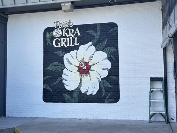 The restaurant's beautiful floral logo blooms on the exterior wall—a fitting symbol for a place where Southern cuisine flourishes in every dish.