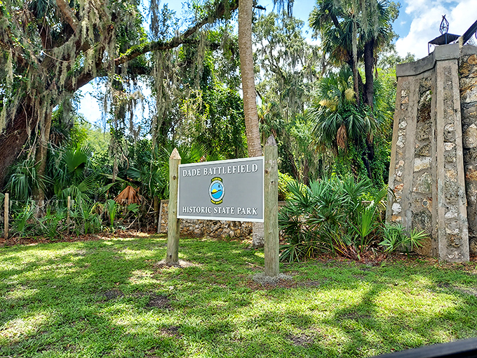 First impressions matter: This understated entrance sign, nestled among native palms, marks the threshold between modern Florida and its storied past.