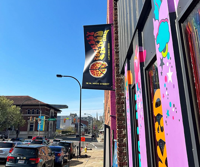 The flag outside waves like a beacon to hungry travelers: "Your pizza pilgrimage ends here, weary food explorer."