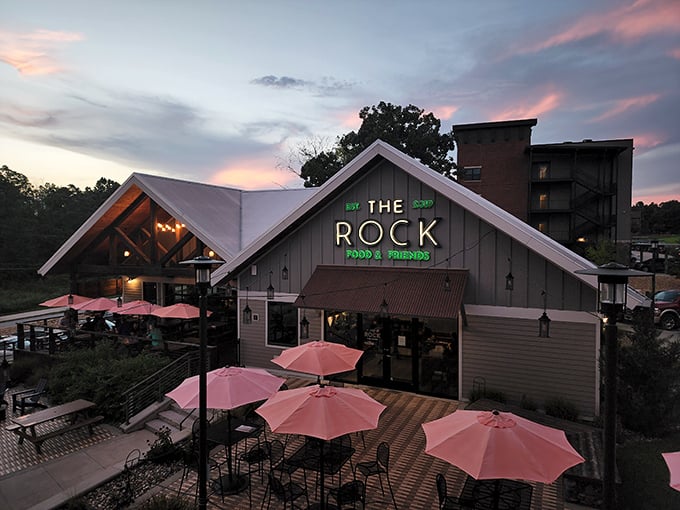 As twilight falls, The Rock's illuminated sign beckons hungry travelers like a lighthouse for the culinarily adrift.