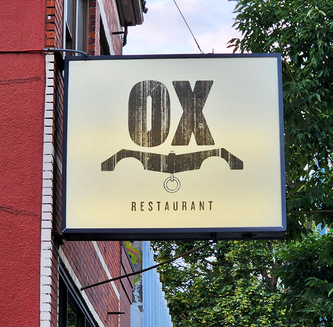 The understated sign outside belies the flavor explosions waiting within&mdash;like finding a treasure map disguised as a simple piece of paper.