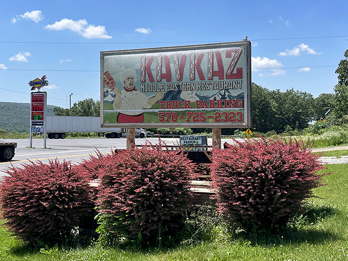 The roadside sign stands as a beacon for hungry travelers. Like a culinary lighthouse guiding ships through seas of chain restaurants.