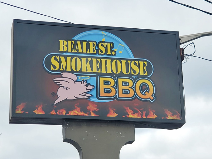 This roadside sign beckons hungry travelers like a barbecue lighthouse, guiding them safely to shores of smoky satisfaction.