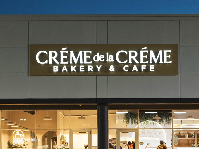 As night falls, the illuminated sign serves as a beacon for those seeking one last sweet bite. European elegance meets Midwest charm in glowing letters.