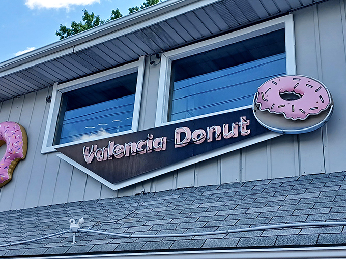 The Valencia Donut sign against blue sky—like a North Star for those navigating by their sweet tooth rather than GPS.