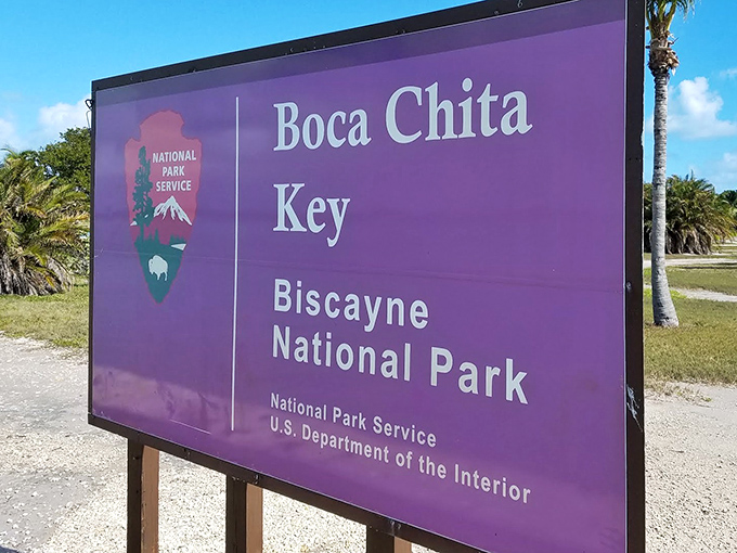 The park's entrance sign promises adventure with government efficiency&mdash;the purple backdrop a surprisingly stylish touch from the National Park Service.