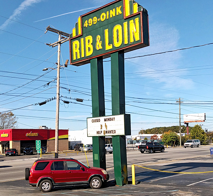 That vintage roadside sign has likely guided hungry travelers for decades. "499-OINK" might be the most appropriate phone number in barbecue history.