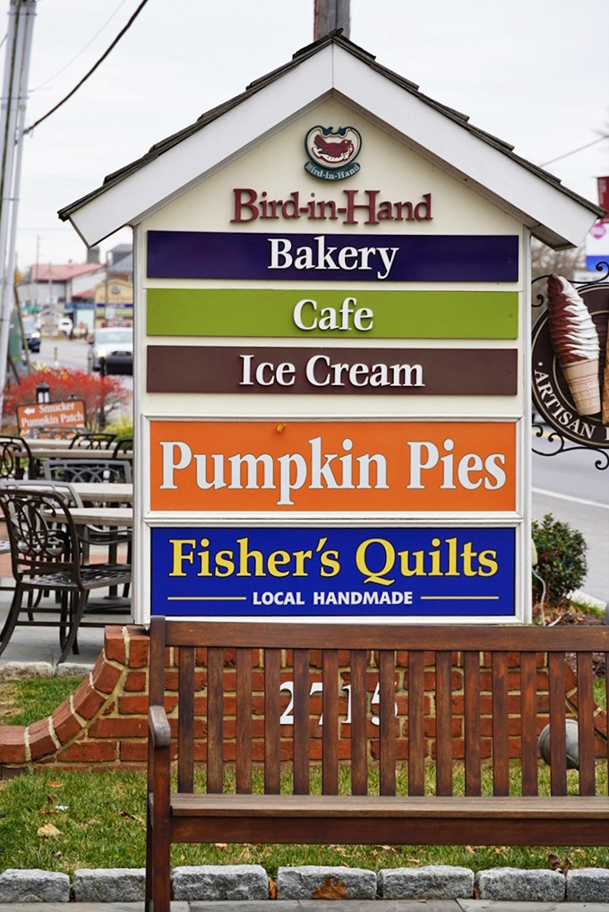 The colorful roadside sign announces not just baked goods but a full-fledged destination—complete with the promise of pumpkin pies that justify the drive.
