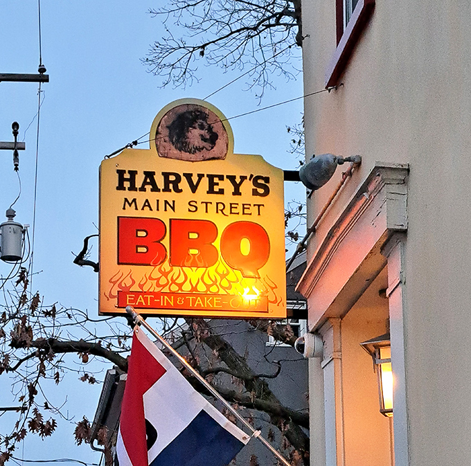 Harvey's illuminated sign glows like a beacon in the evening sky &ndash; not all heroes wear capes, some just smoke meat to perfection.