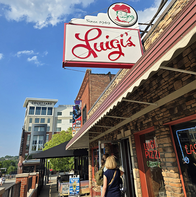 Luigi's sign glows like a beacon of hope for hungry travelers, promising that inside these brick walls, everything is going to be deliciously alright.