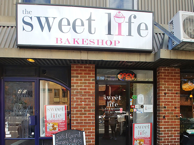 The illuminated sign serves as a beacon of hope for the dessert-deprived, promising sweet salvation just steps away from Philadelphia's bustling streets.