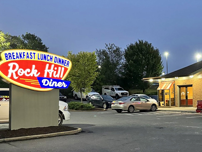 The neon sign glows like a beacon in the evening sky, promising breakfast all day &ndash; three words that sound like poetry to hungry travelers.