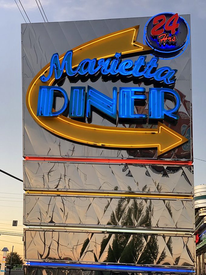 The iconic neon sign shines like a lighthouse for the hungry, that "24 Hours" promise more comforting than a lullaby when midnight cravings strike.