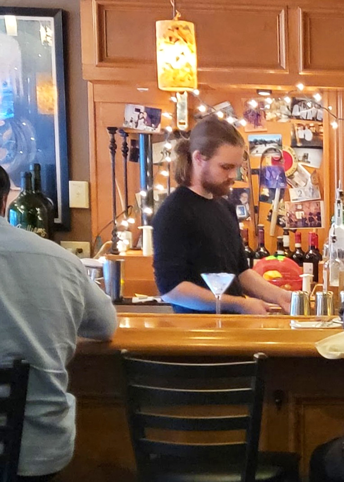 Behind the bar, where cocktail magic happens and the bartender knows exactly when you need another round.