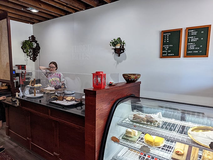 Behind the counter magic where flour transforms into joy. The display case holds treasures more valuable than gold&mdash;at least to your taste buds.